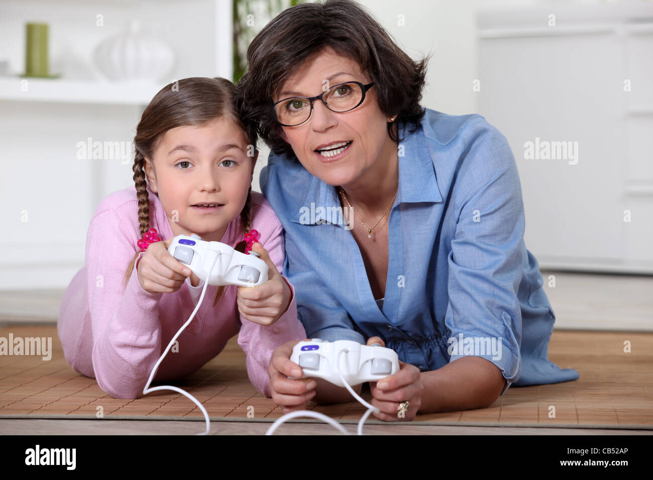 Mother and daughter playing video games Stock Photo - Alamy