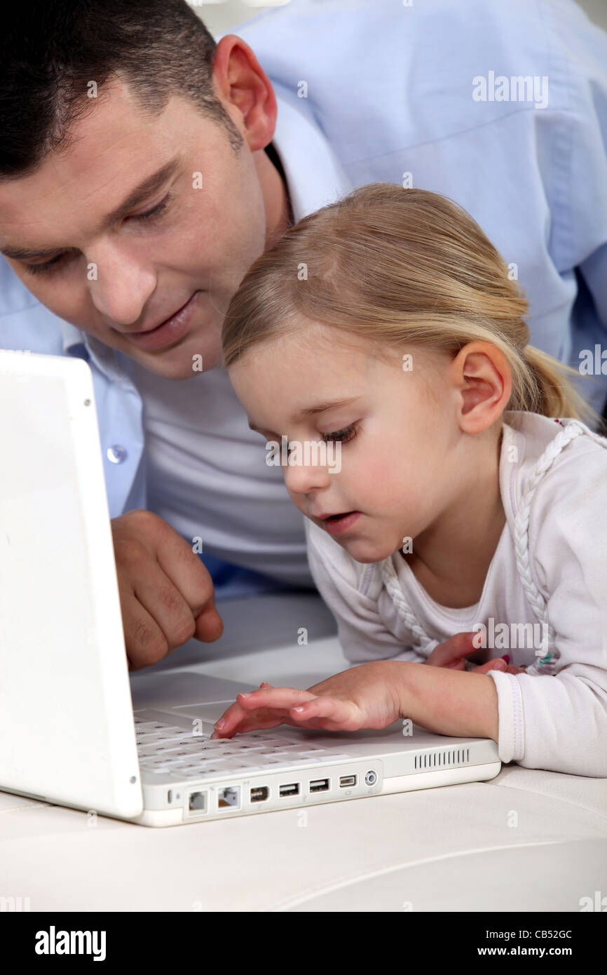 Father and daughter using a laptop computer Stock Photo - Alamy