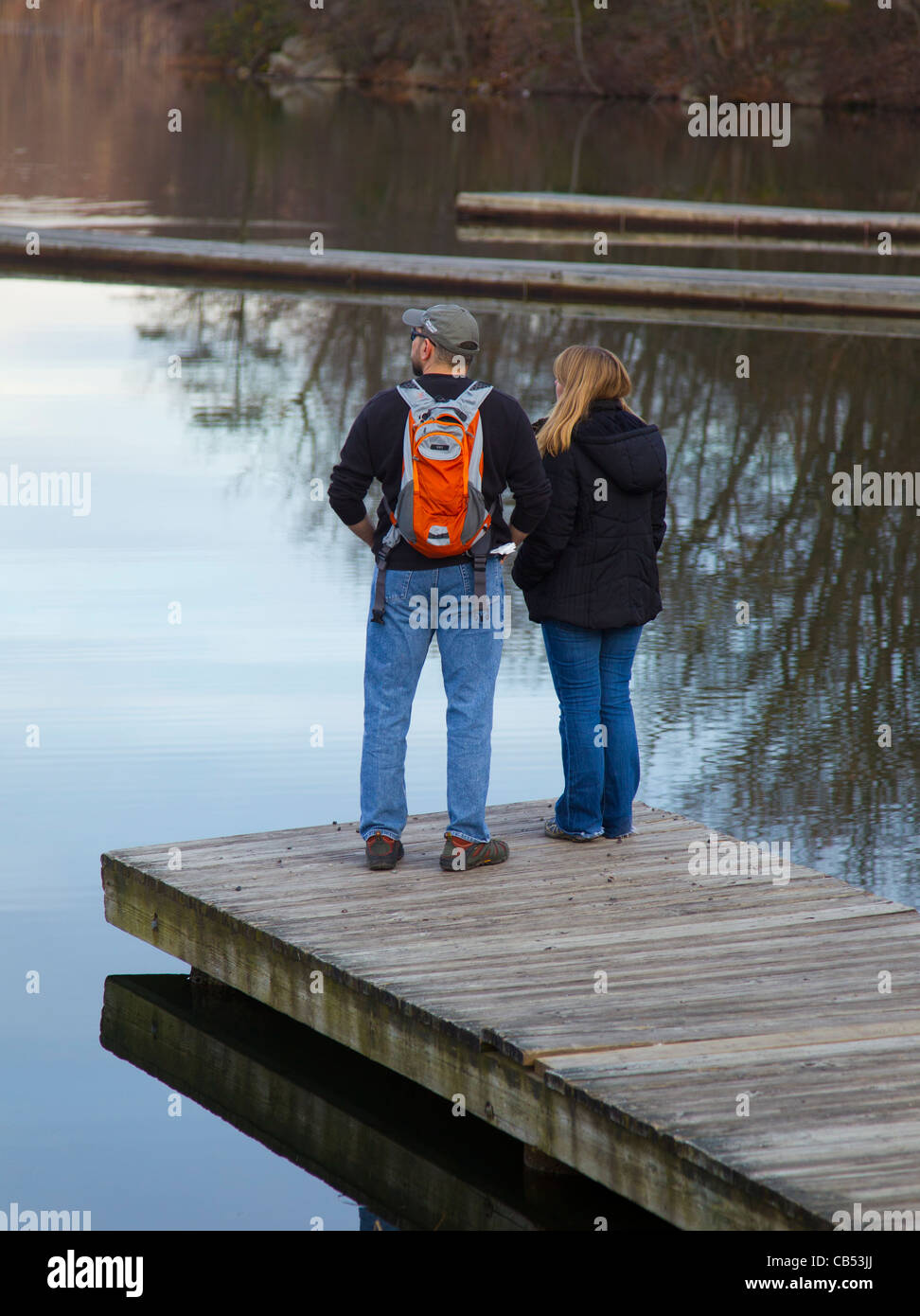 A young couple standing on a dock Stock Photo - Alamy