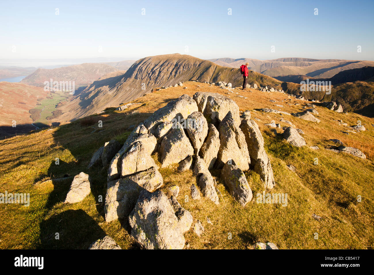 A woman walking on the Helvellyn Range in the Lake District, UK., on ...