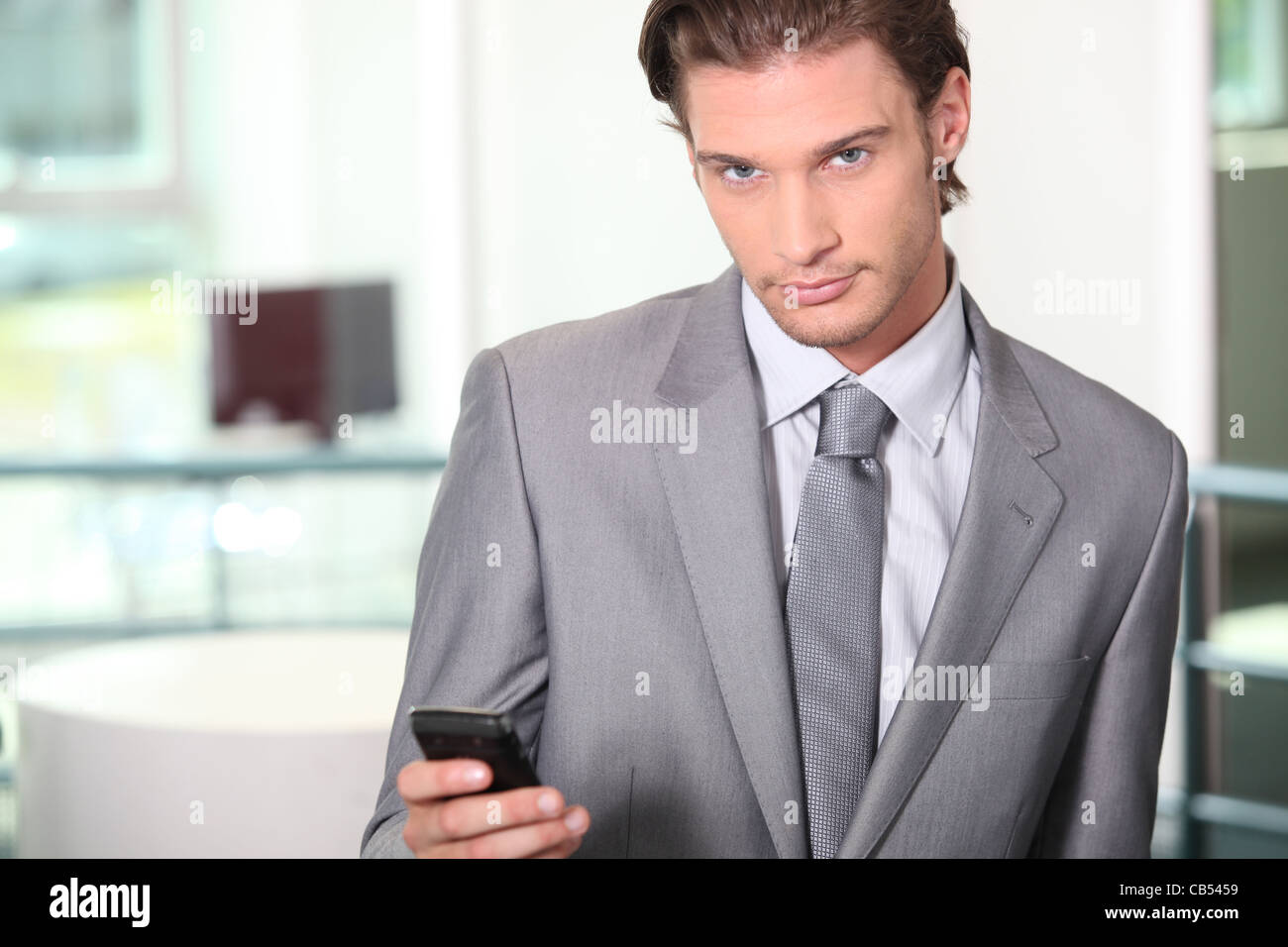 Executive using a cell phone Stock Photo - Alamy