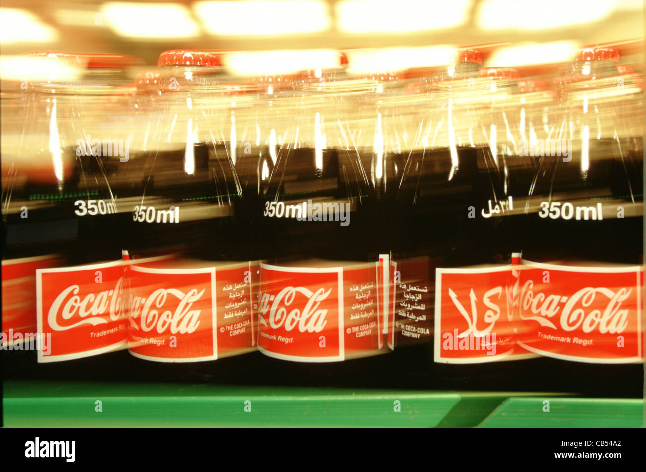 Bottles of Coca-Cola on the production line at a bottling plant in the ...