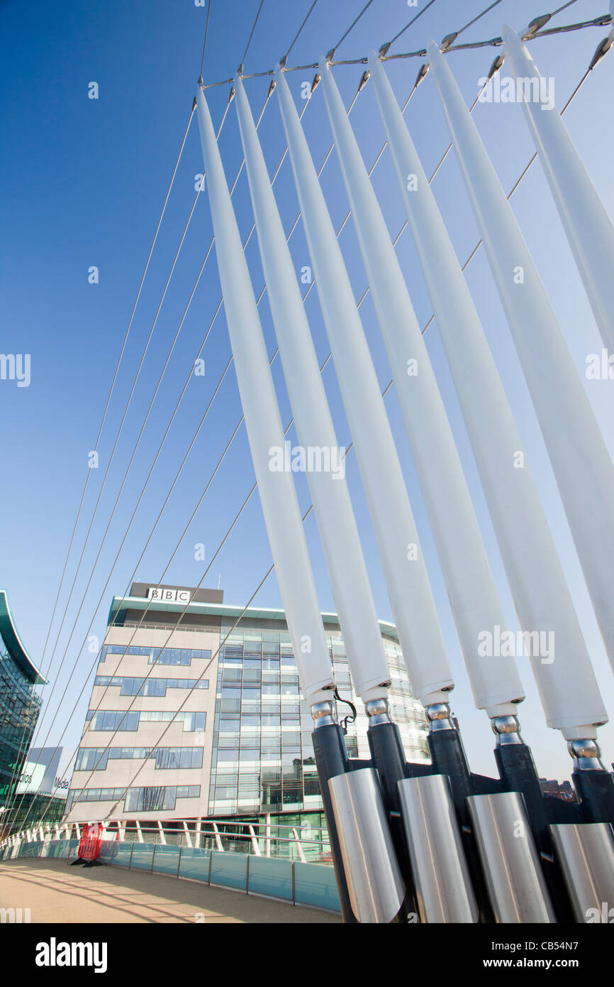 A modern pedestrian suspension bridge over the Manchester ship Canal at ...