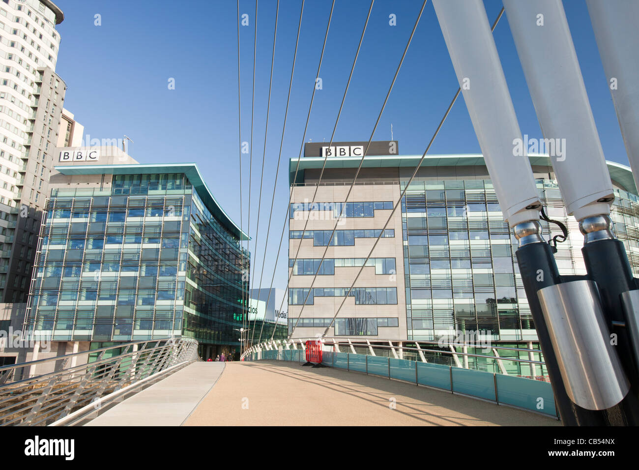 A modern pedestrian suspension bridge over the Manchester ship Canal at ...