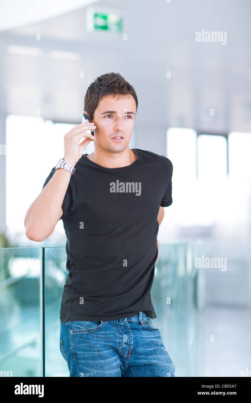 Handsome young man using his mobile phone/speaking on the phone Stock ...