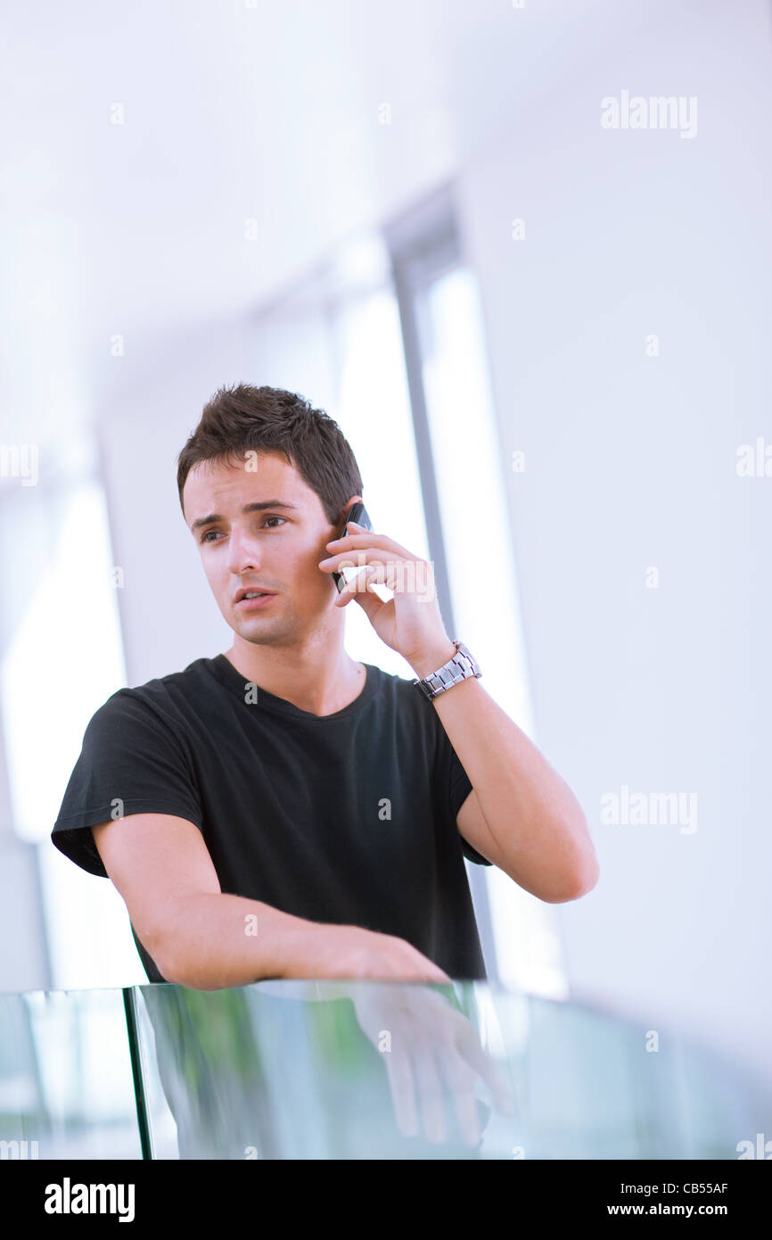 Handsome young man using his mobile phone/speaking on the phone Stock ...