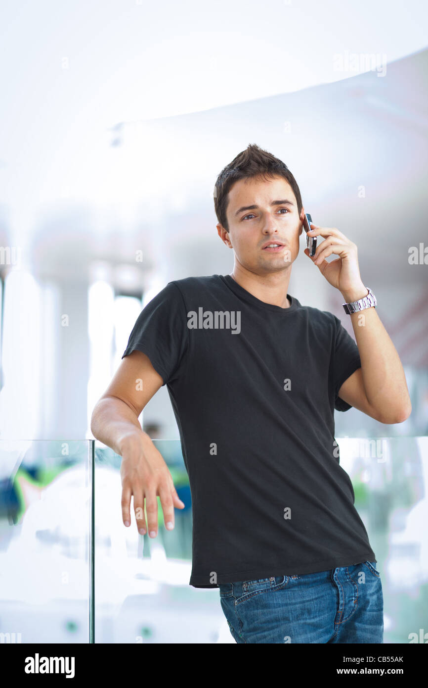 Handsome young man using his mobile phone/speaking on the phone Stock ...