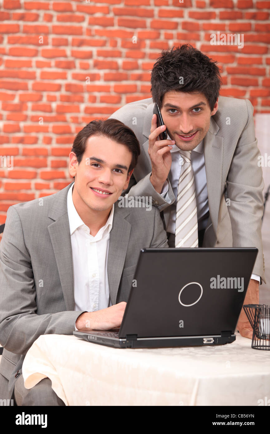 Young men using a laptop in a restaurant Stock Photo - Alamy
