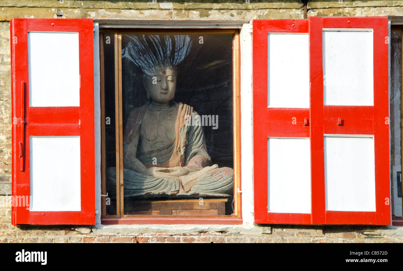 Buddha in the house window Stock Photo - Alamy
