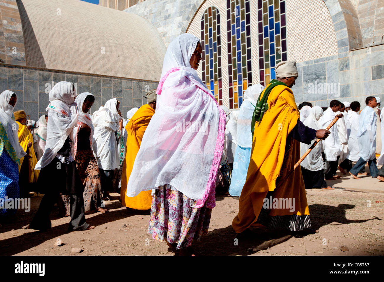 A procession of Orthodox Christian devotees walk around the new church ...
