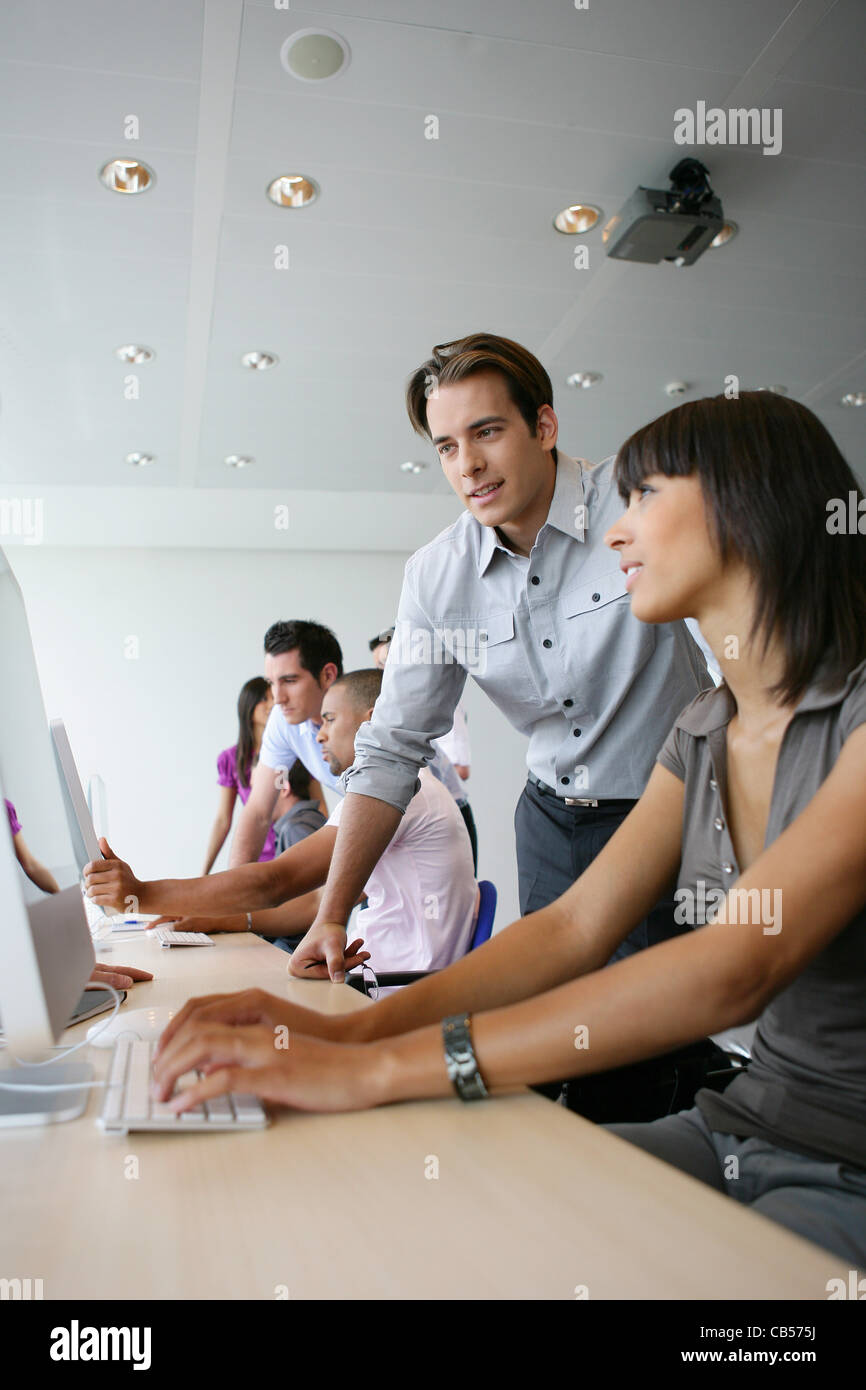 Young people working at computers Stock Photo - Alamy