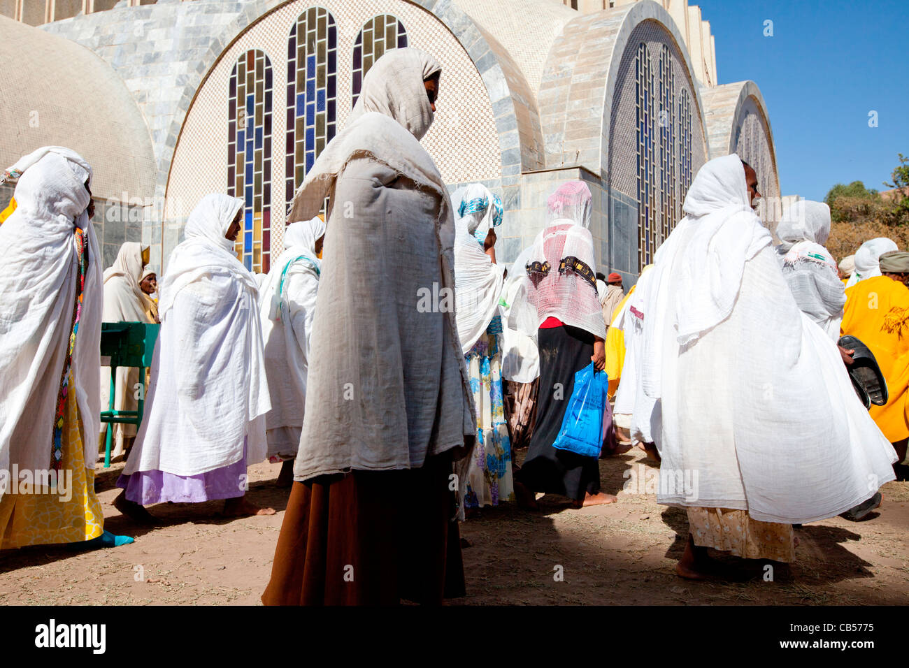 A procession of Orthodox Christian devotees walk around the new church ...