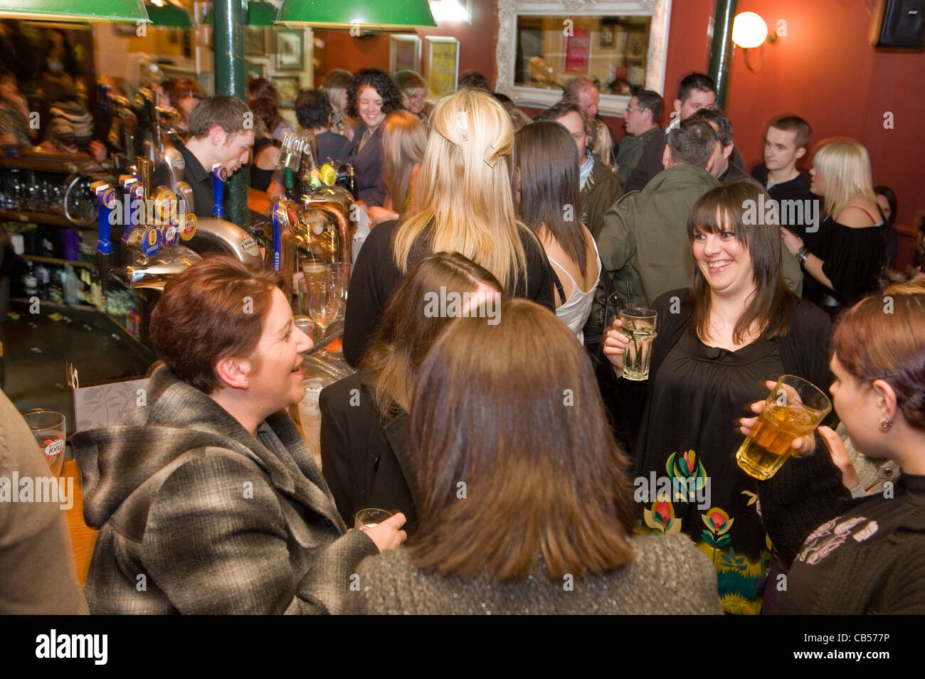 Busy bar filled with young males and females Stock Photo - Alamy