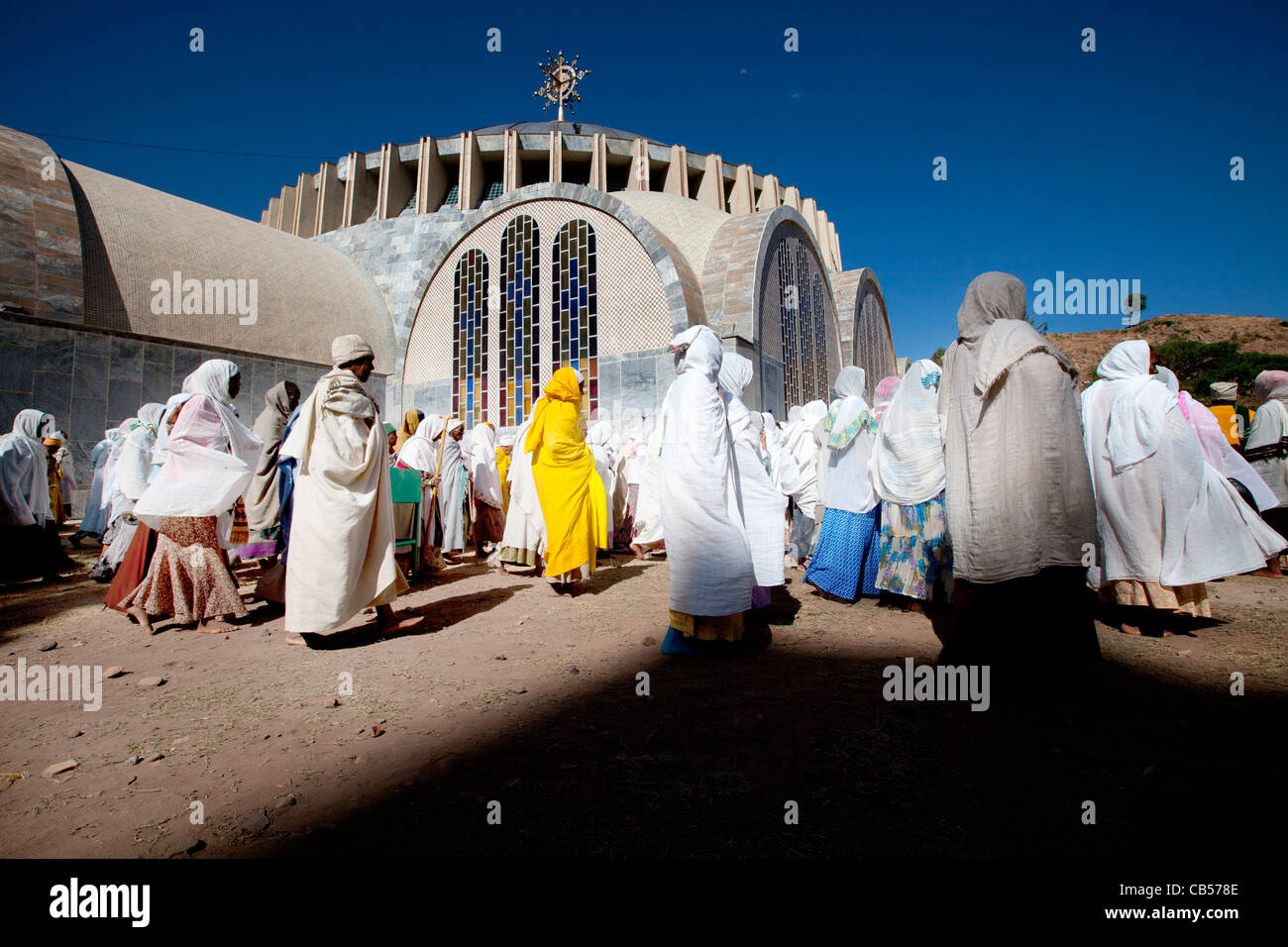 A procession of Orthodox Christian devotees walk around the new church ...