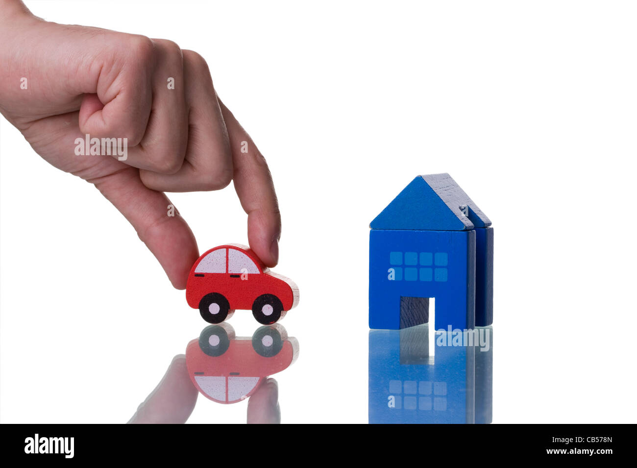 a hand showing a house and a car isolated with reflection Stock Photo ...