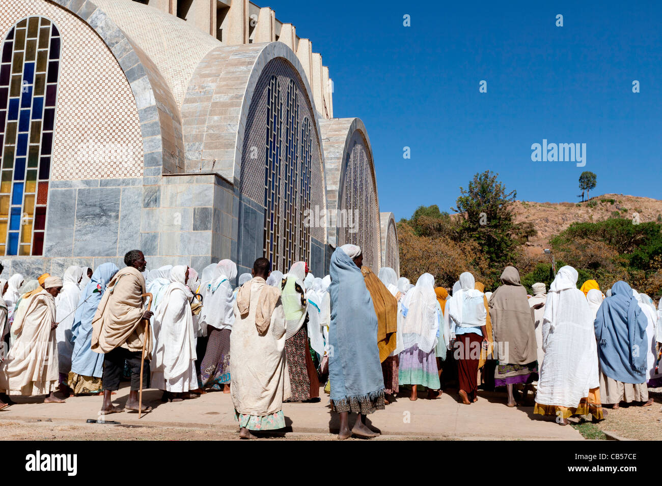 A procession of Orthodox Christian devotees walk around the new church ...