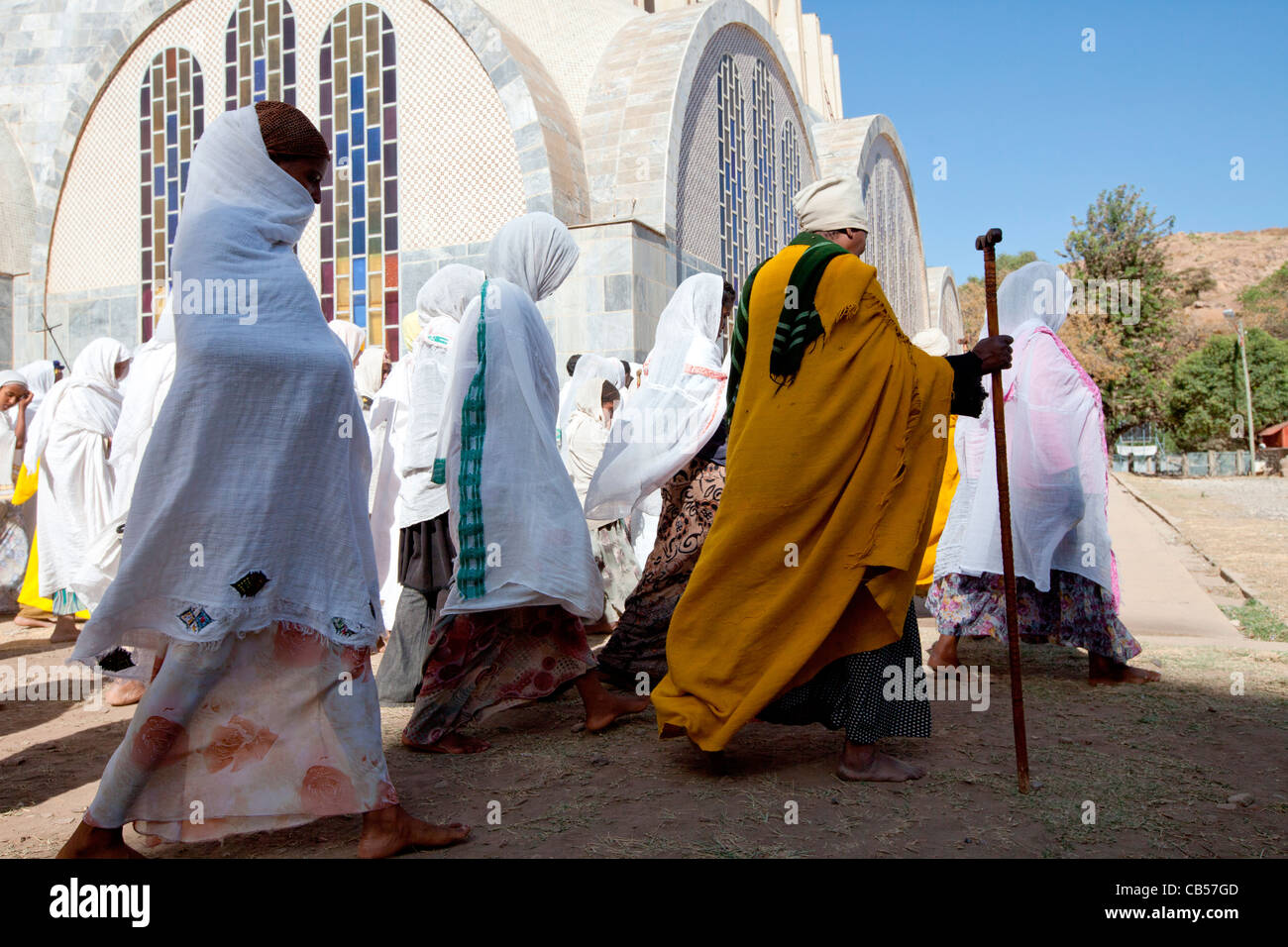 A procession of Orthodox Christian devotees walk around the new church ...