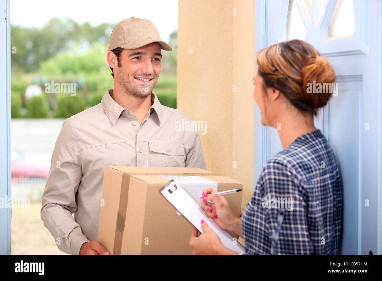 Courier delivering a parcel Stock Photo - Alamy