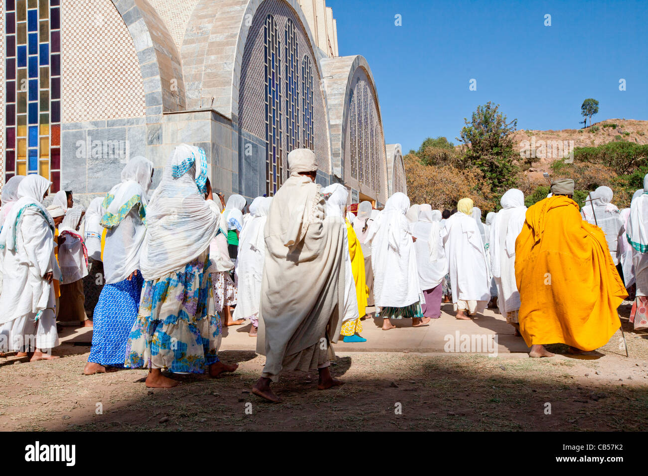 A procession of Orthodox Christian devotees walk around the new church ...