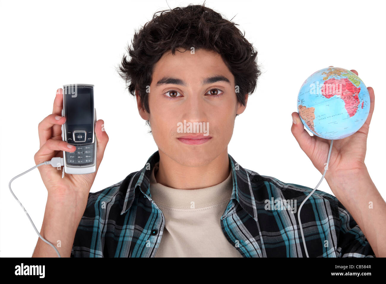 a teenage boy connecting a cell phone and a globe Stock Photo - Alamy