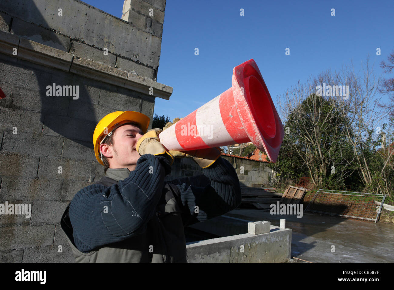 Man shouting through traffic cone Stock Photo - Alamy