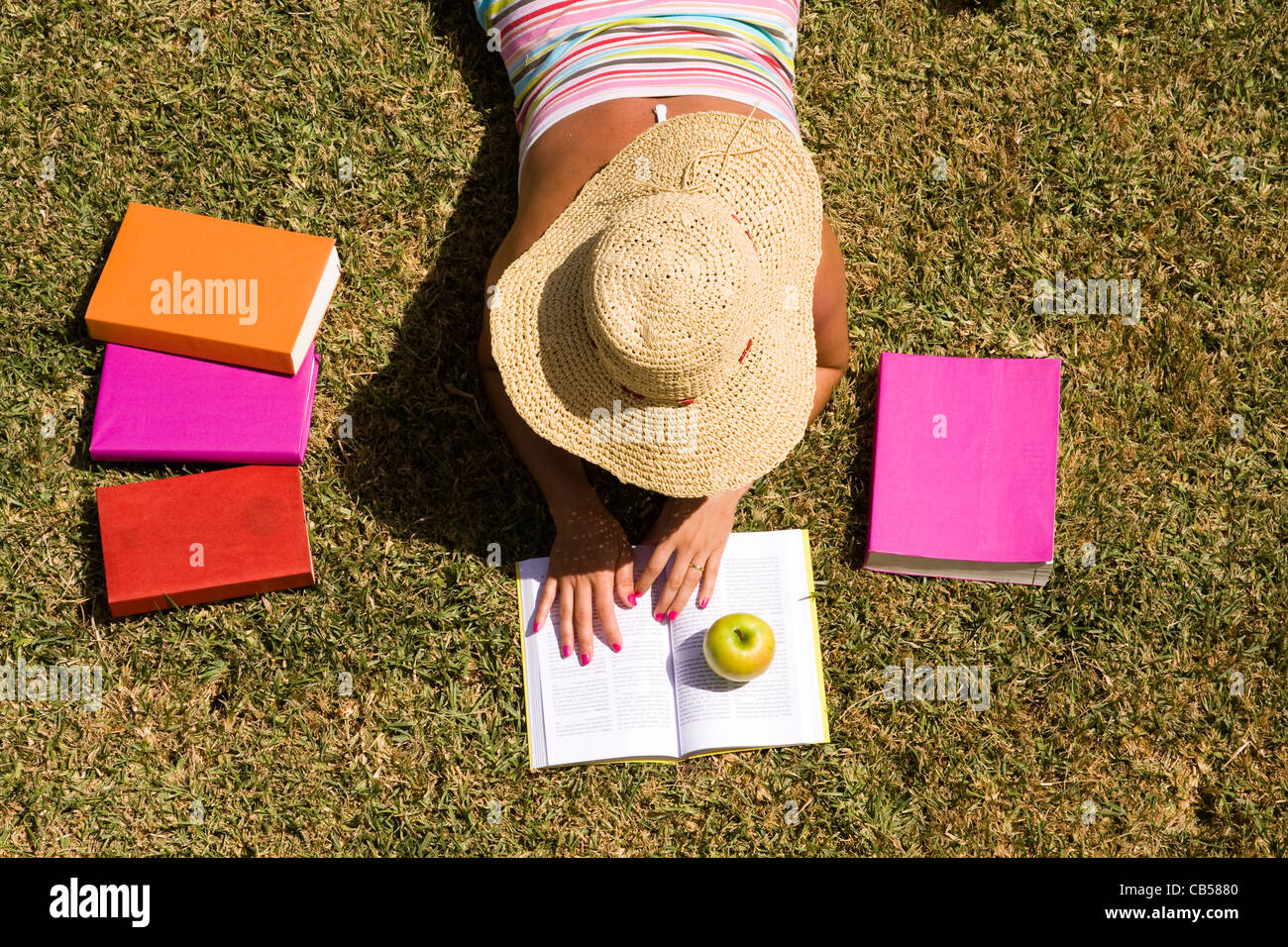 a student relaxing at the grass of the school park (the pages in the ...