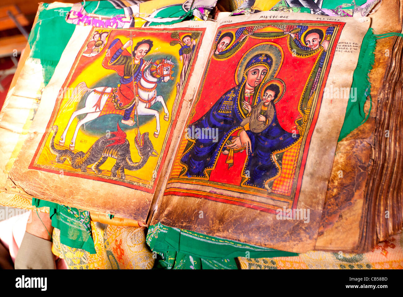 A chapel guardian displays an ancient illuminated manuscript at the New ...
