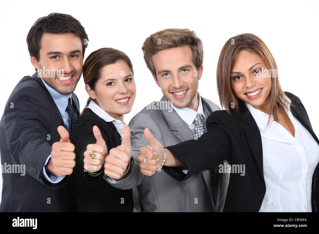 Four young professionals giving the thumbs up Stock Photo - Alamy
