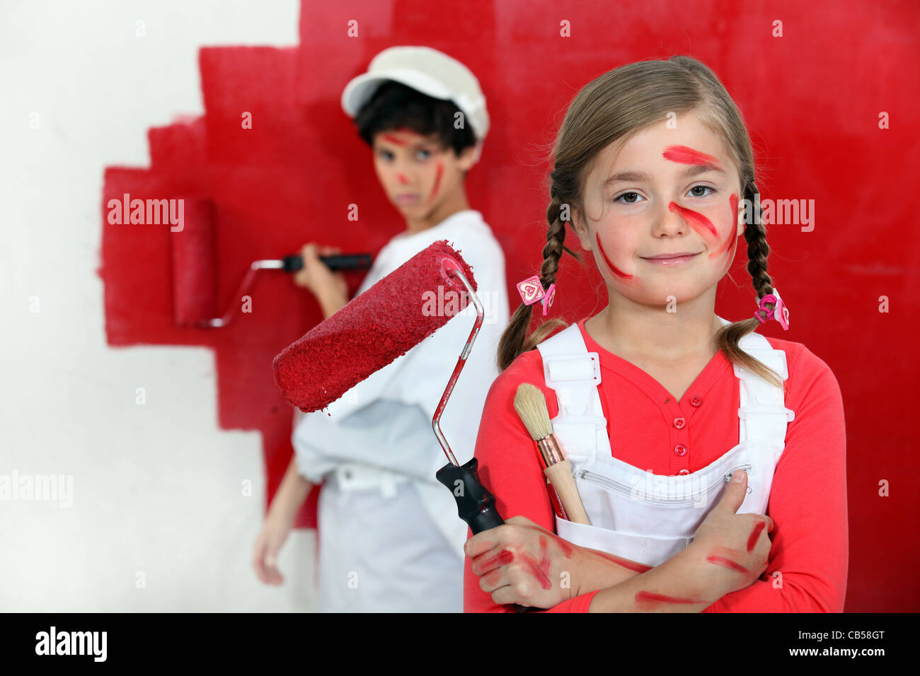 Children painting a wall red Stock Photo - Alamy