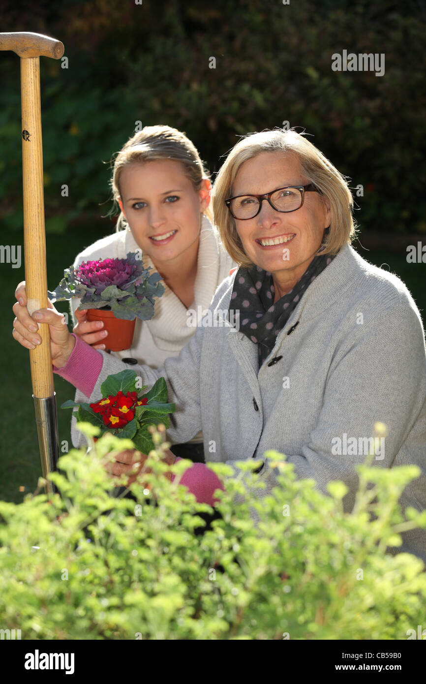 Women planting flowers Stock Photo - Alamy
