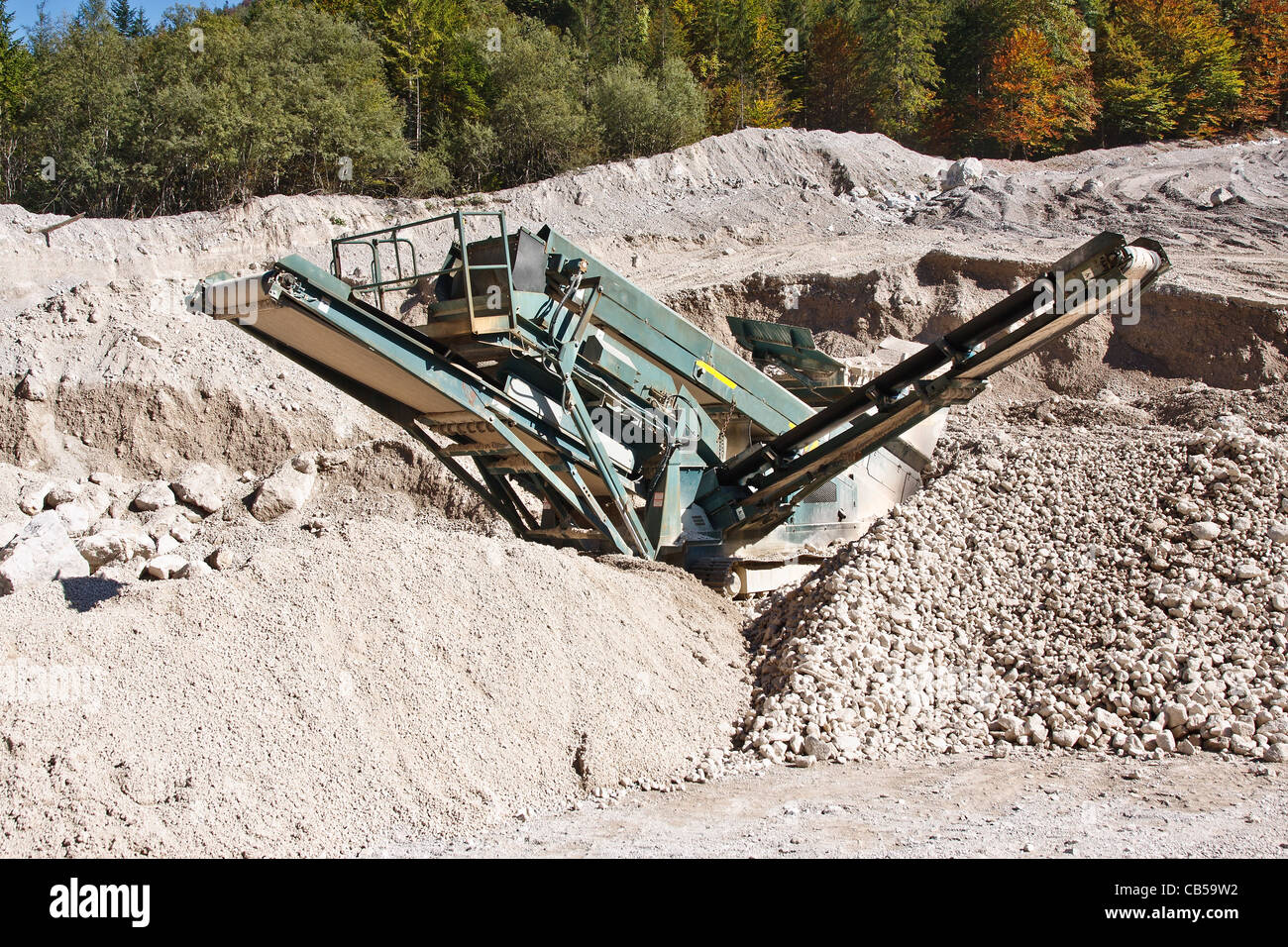 Making of crushed stone at stone quarry Stock Photo - Alamy