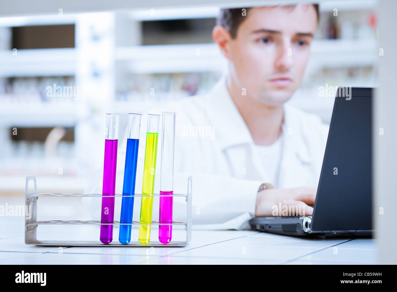 young male researcher carrying out scientific research in a lab ...