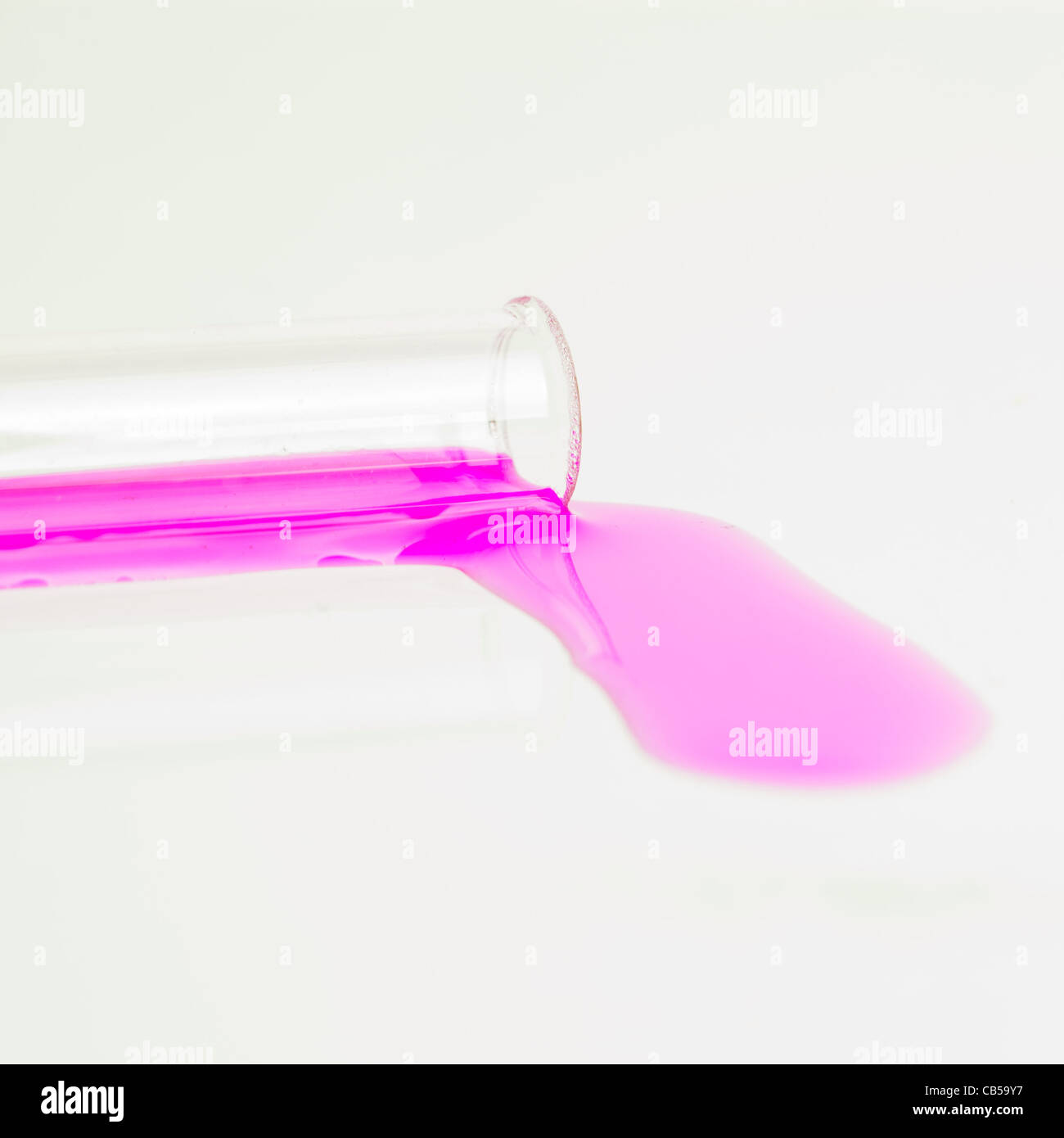 test tubes with colorful substances spilled on a white table in a lab ...