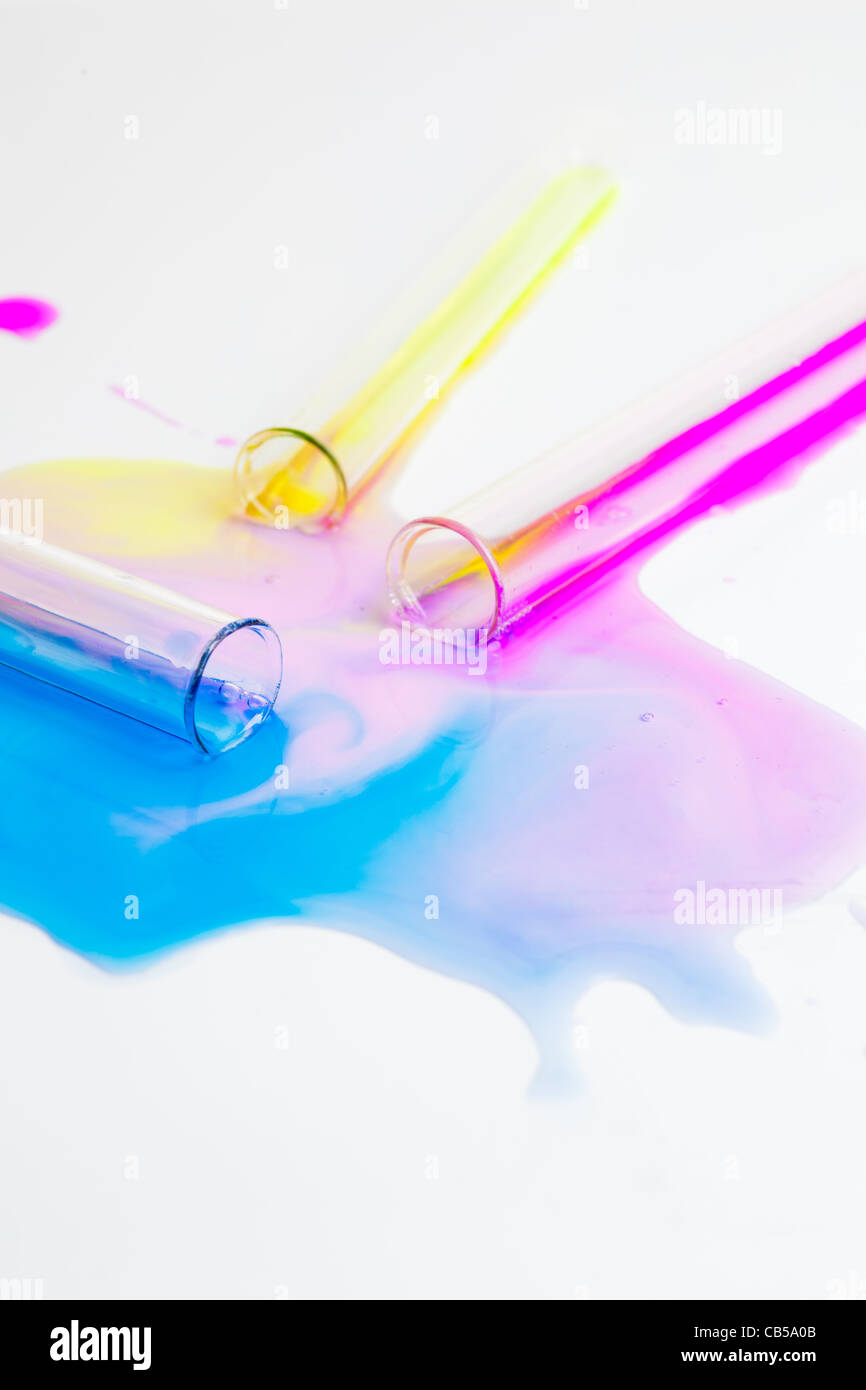 test tubes with colorful substances spilled on a white table in a lab ...