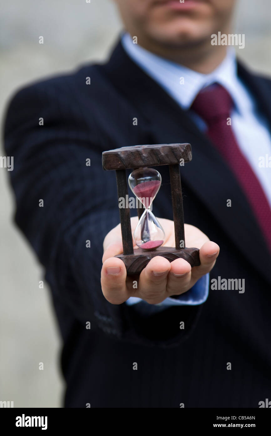 a businessman showing how to save time (selective and soft focus Stock ...