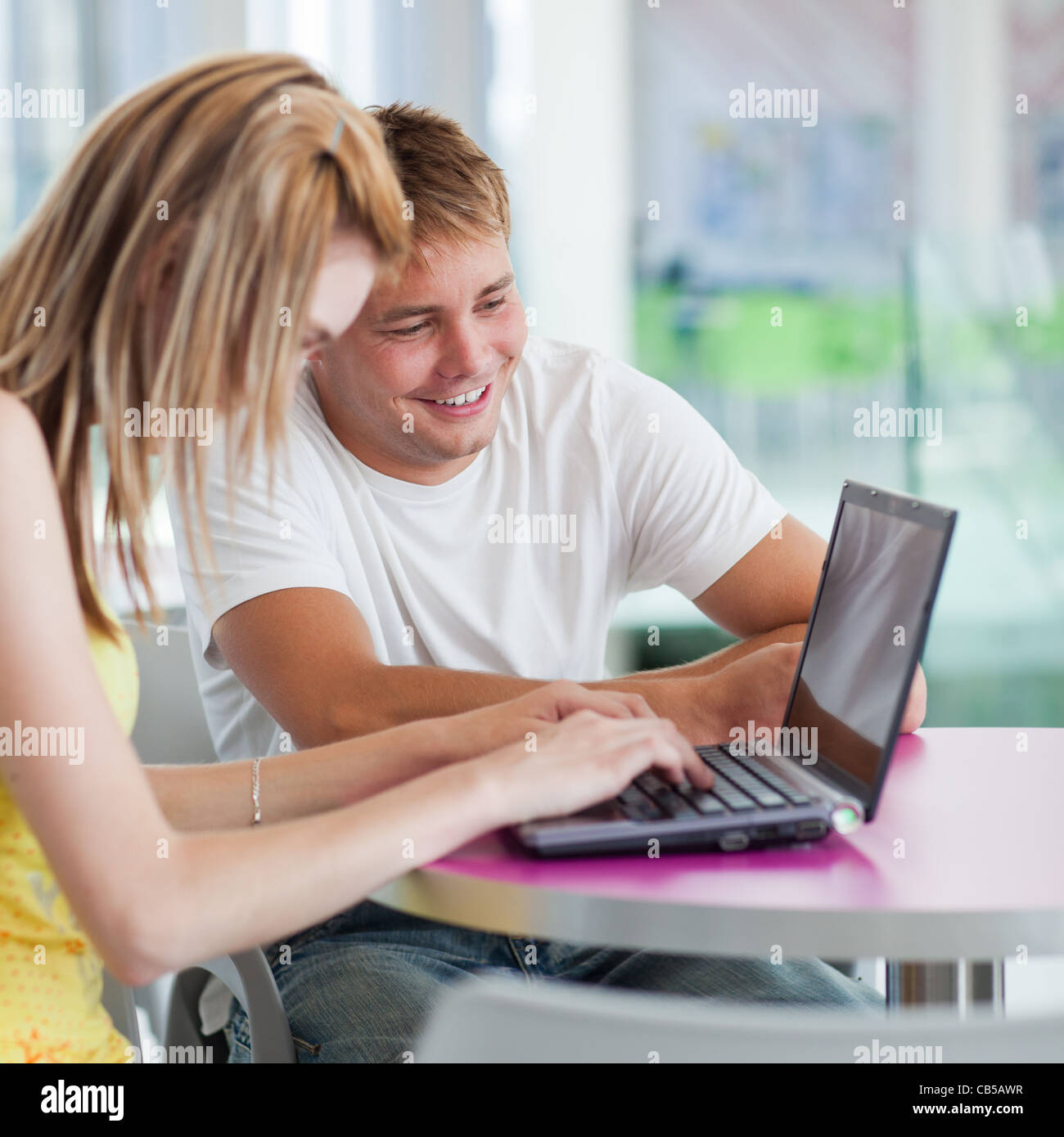 two college students studying together, using a laptop computer Stock ...