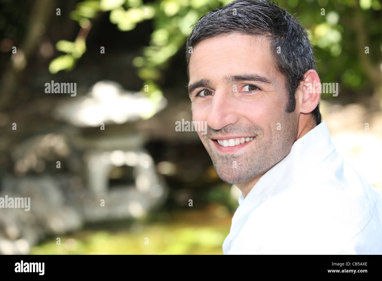 Man in a Zen garden Stock Photo - Alamy