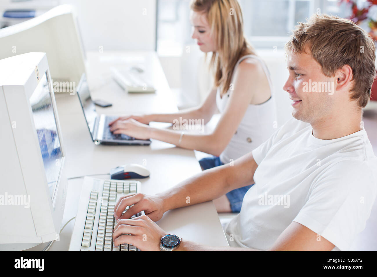 two college students studying together, using a laptop computer Stock ...