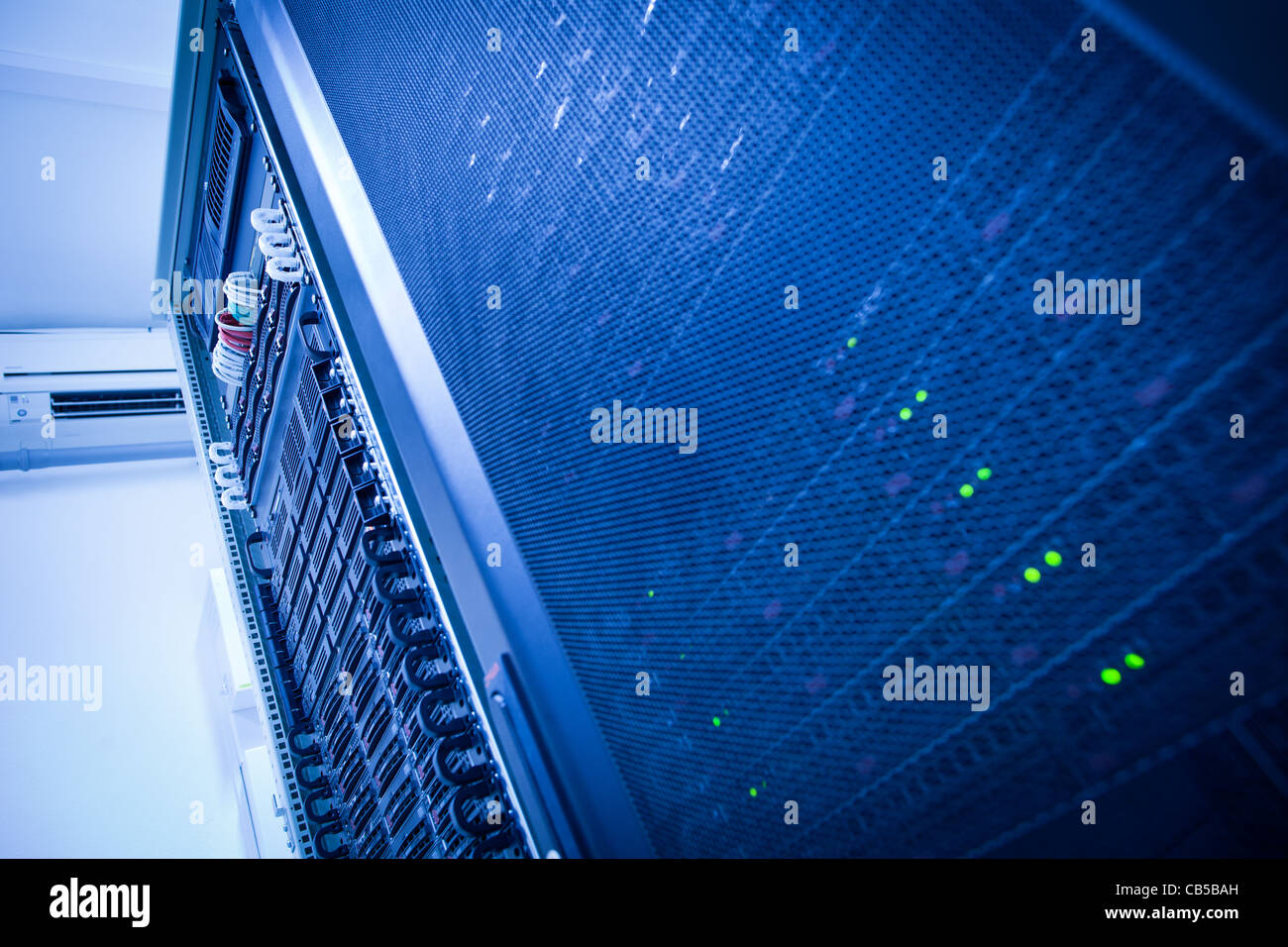 Server rack cluster in a data center (shallow DOF; color toned image ...