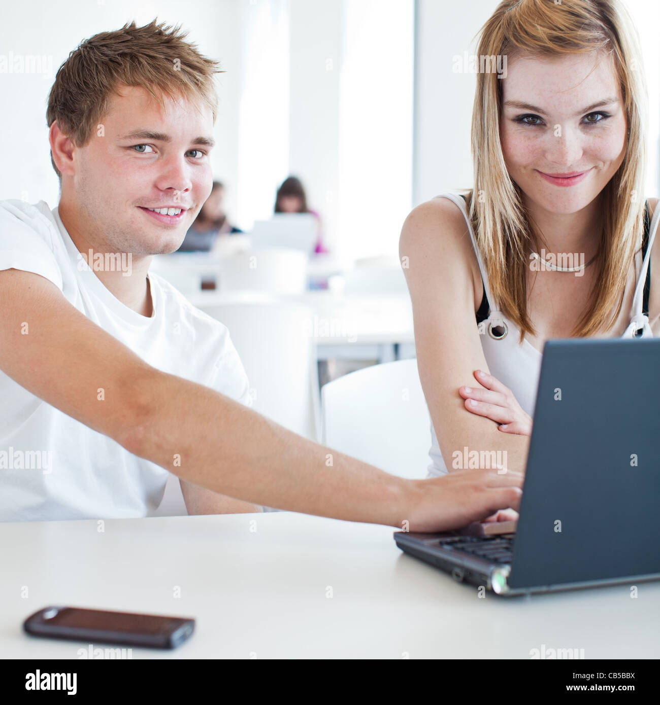 two college students studying together, using a laptop computer Stock ...
