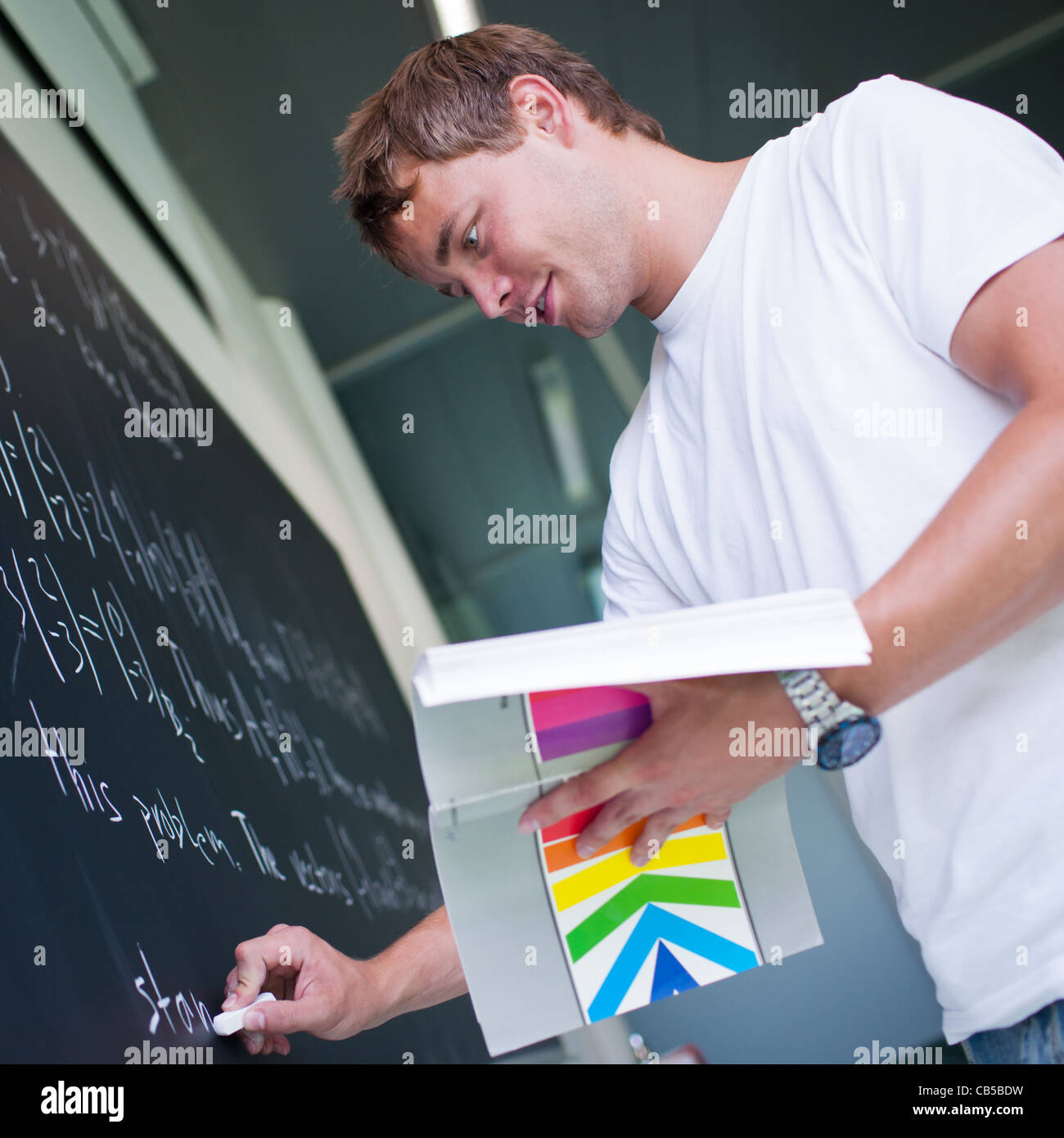 handsome college student solving a math problem during math class in ...