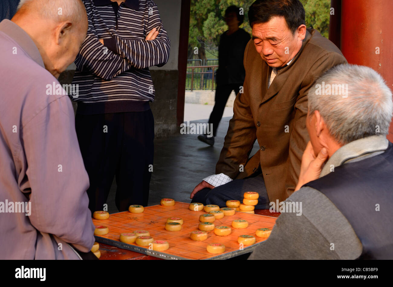 Group of men watching pair play Chinese Chess or Xiangqi in Beijing ...