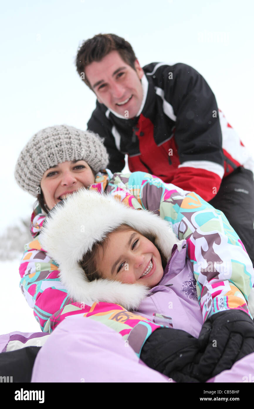 Family playing in the snow Stock Photo - Alamy