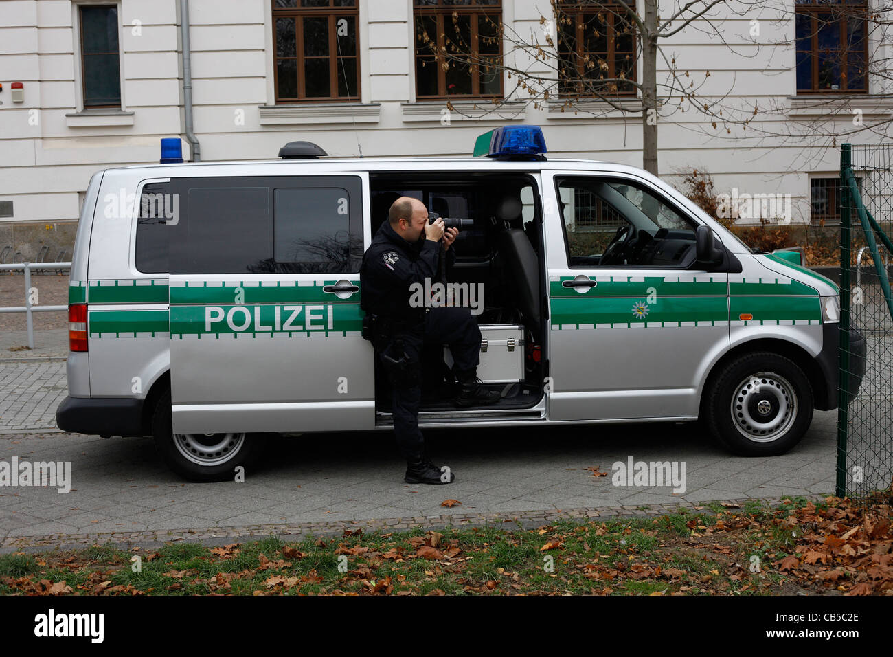 A German policeman taking photographs in Leipzig Germany Stock Photo ...