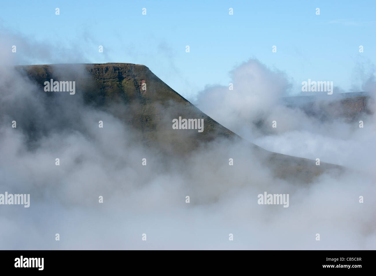 HIll in cloud from temperature inversion Stock Photo - Alamy