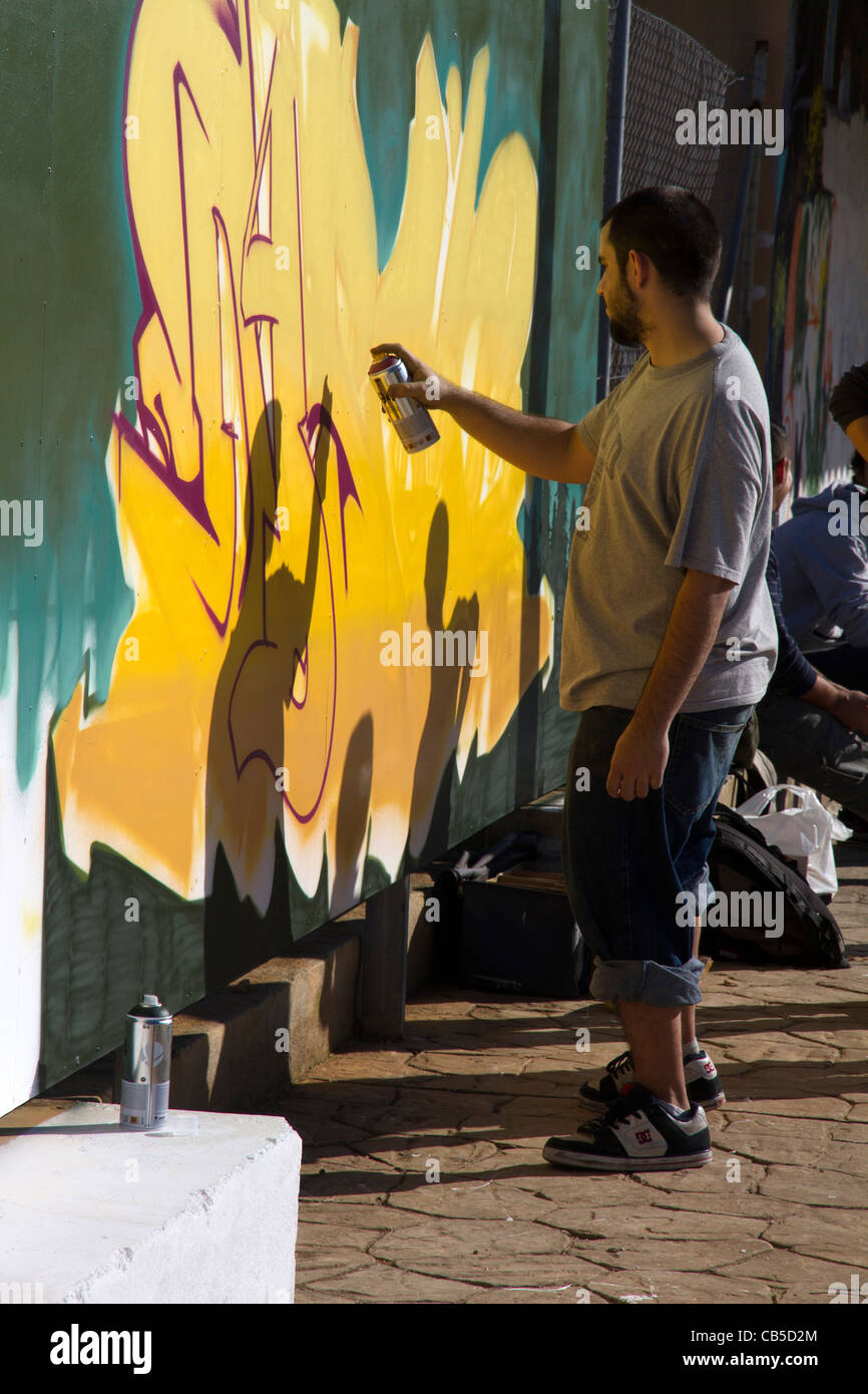 young man doing graffiti wall painting murales colors color Mallorca ...