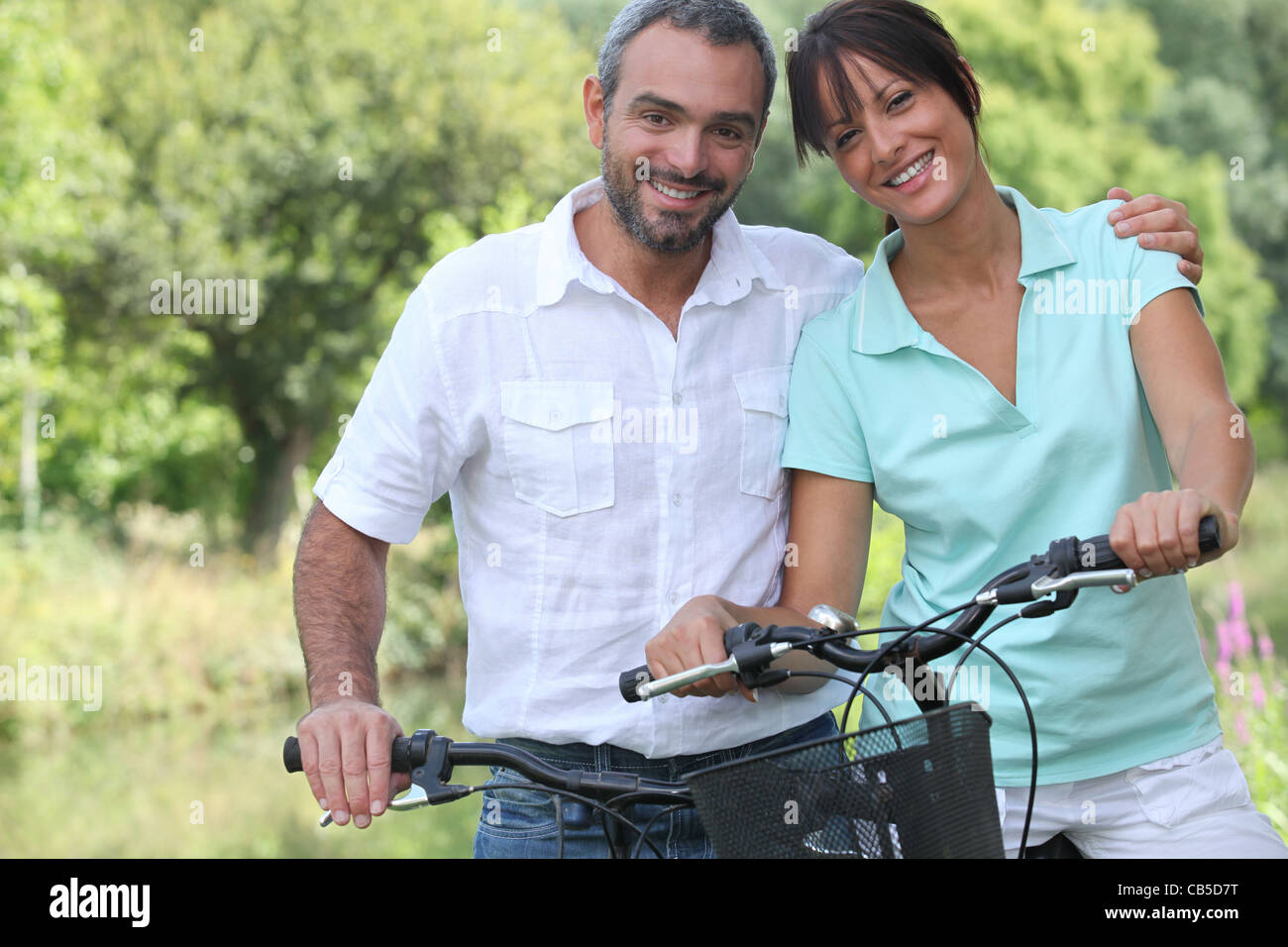Couple riding bikes Stock Photo - Alamy
