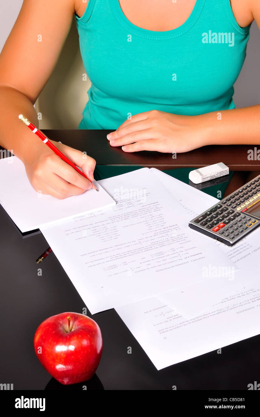 Student doing maths exercises with a calculator and a red pencil Stock ...