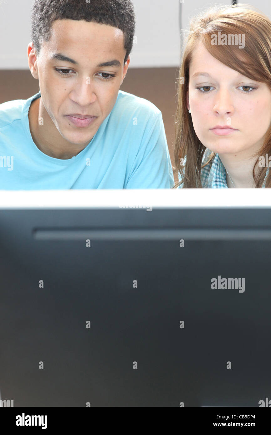 Two teenagers in front of computer Stock Photo - Alamy