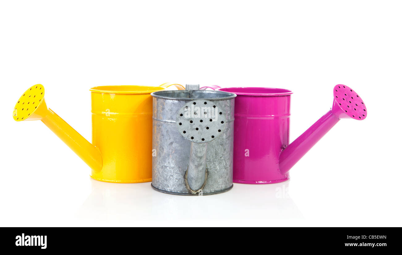 Three colorful watering cans over white background Stock Photo - Alamy